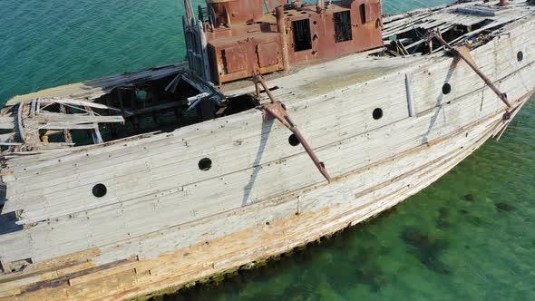 A Wrecked Wooden Ship Lies on the Seashore Covered with Rust, Stock Footage