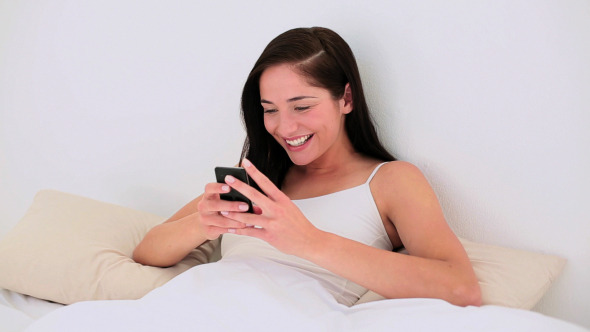 Attractive Brunette Texting On Her Smartphone, Stock Footage | VideoHive