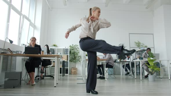 Pretty Young Woman Performing Creative Modern Dance in Workplace While ...
