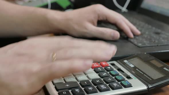 The Man at the Computer Counts the Numbers on the Calculator and ...