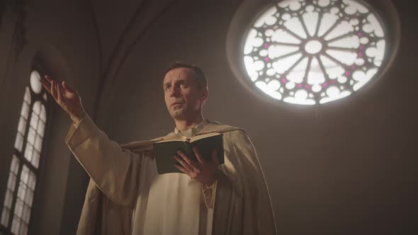 Priest with Bible Preaching Sermon in Catholic Church, Stock Footage