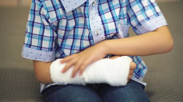 Girl Child With Broken Sick Hand In Plaster Plays Home In Bedroom ...