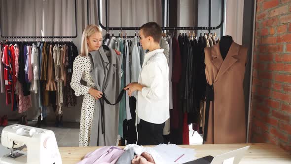 Caucasian Female Fashion Designer Work and Try Clothes on Beautiful ...