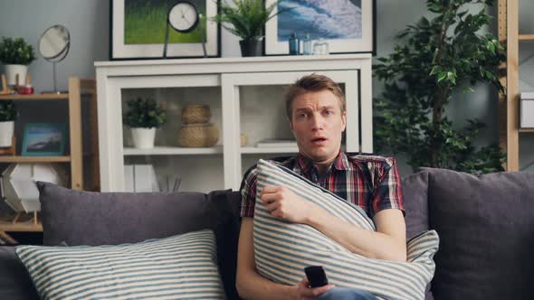 Zoom-in of Emotional Young Man Crying Over Sad Movie on TV Sitting on ...