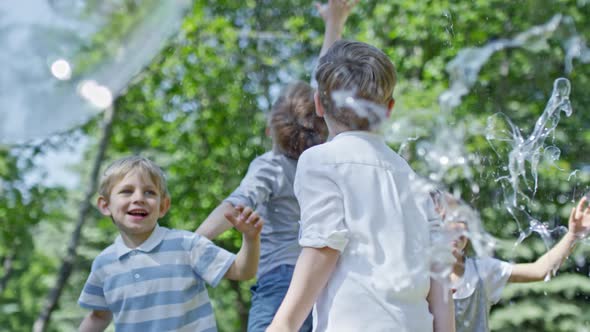 Exhilarated Kids Catching Bubbles in Park, Stock Footage | VideoHive