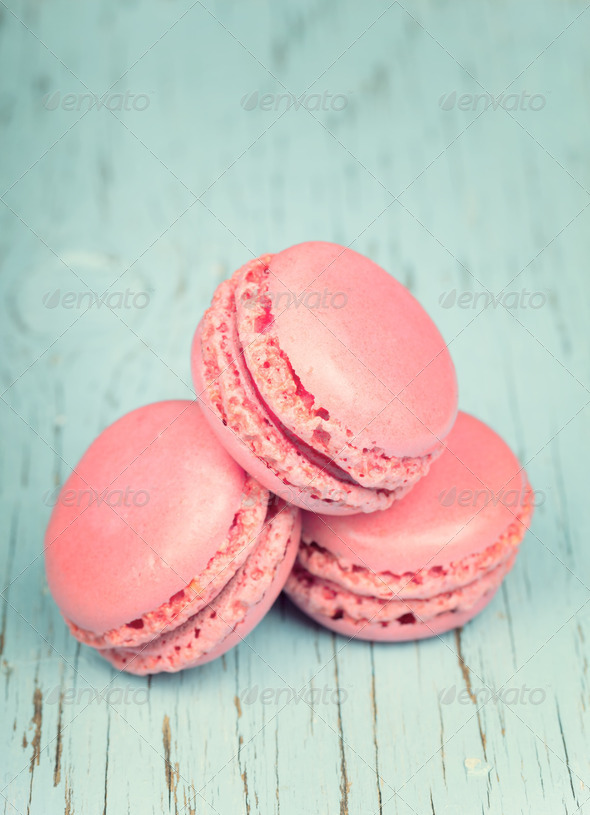 Two pink macaroons on wooden baby blue background Stock Photo by iMarly