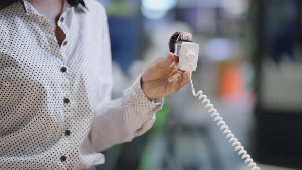Young Woman is Choosing Smartwatch in Electronics Shop Holding ...