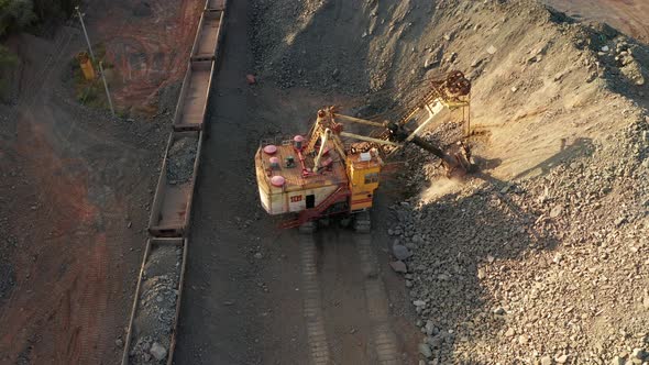 Aerial View of Large Excavator Loads Iron Ore Into Train Carriages ...