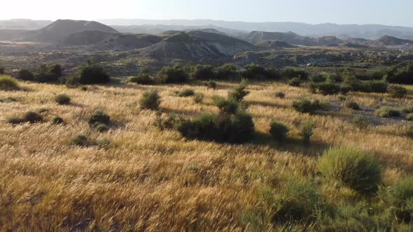 Flying over the ridge of a cliff in the tabernas desert during the ...