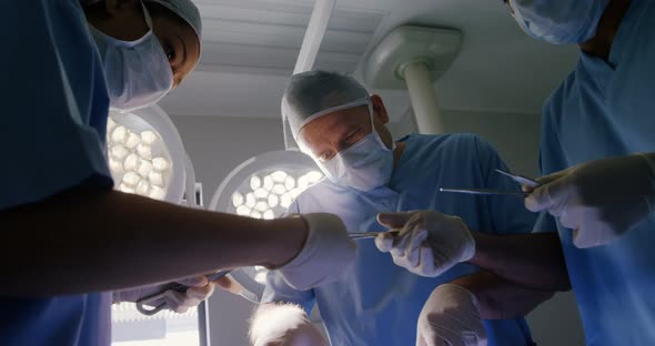 Multi-ethnic group of male and female surgeons working together in a ...