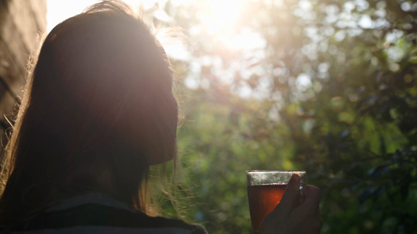 Woman Having Tea Outdoor During Sunset, Stock Footage | VideoHive