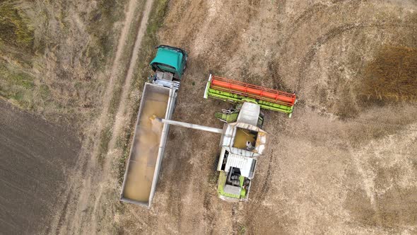Aerial View of Combine Harvester Unloading Grain in Cargo Trailer ...
