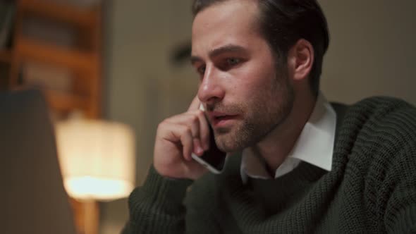 Sad man talking by phone and looking at laptop, Stock Footage | VideoHive
