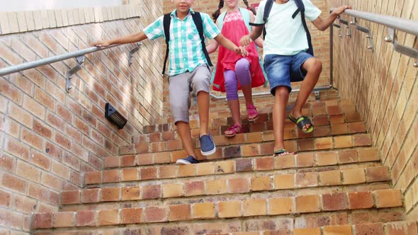 Smiling schoolkids walking on staircase at school, Stock Footage ...
