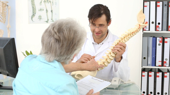Chiropractor Showing Spine Model To His Patient, Stock Footage | VideoHive