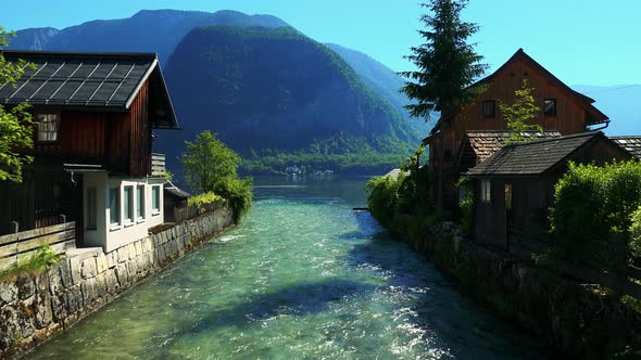 River Flowing Between Houses in Historical Village - Mountain with Lake ...