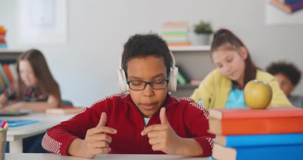 Portrait of Preteen African Kid in Headphones Rapping Sitting at Desk ...