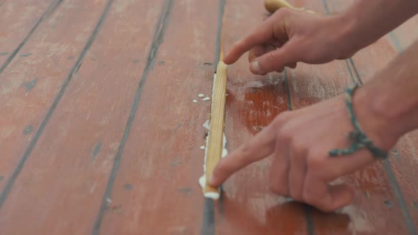 Fitting wooden spline insert into wooden roof planking on boat, Stock ...