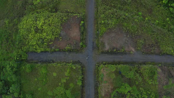 Aerial top view of a crosspoint of two dirt roads, making a perfect ...