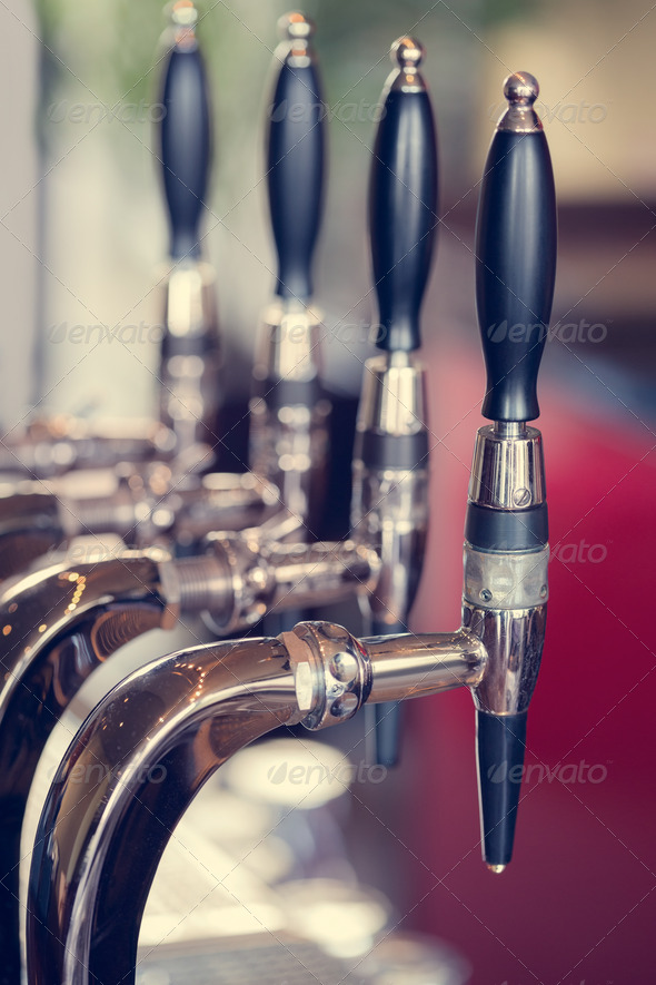 Silver and black beer taps close up in a pub Stock Photo by Wavebreakmedia