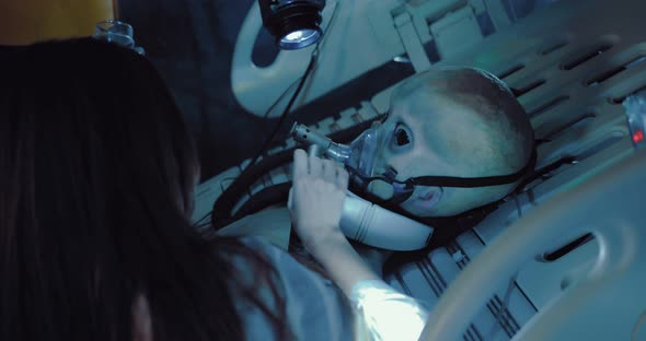 Medical Scientist Checks the Sensors Connected to the Alien, Stock Footage