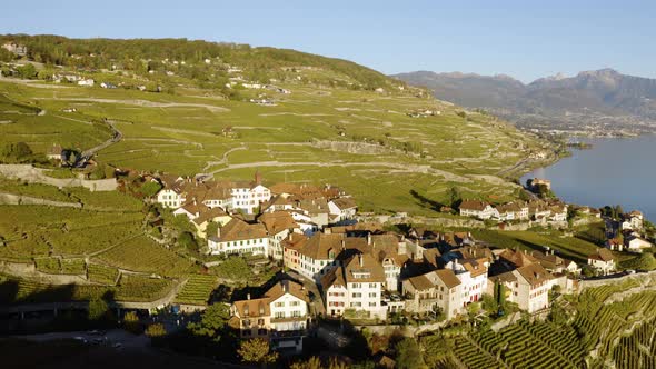 Orbiting then overflying typical village (Rivaz) in Lavaux vineyard ...
