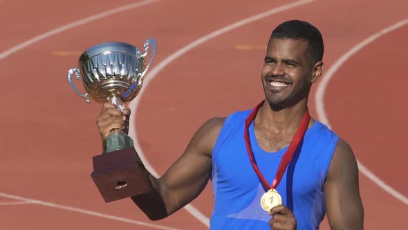Athlete Holding Cup in Hands, Celebrating Victory in Sports Competition ...