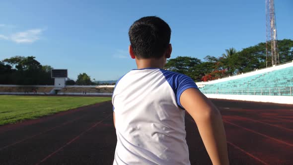 Back View Of Boy Running At Stadium, Stock Footage | VideoHive