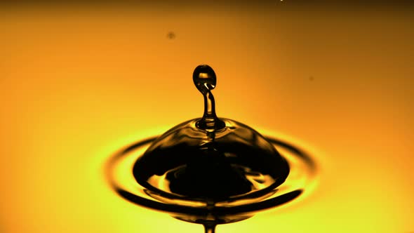 Drop Of Fuel Oil Dripping And Creating Bubble On The Yellow Surface by ...
