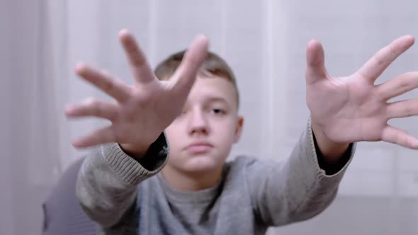 Sad Child Waving Hands Goodbye Hello Bye While Sitting on an Armchair ...