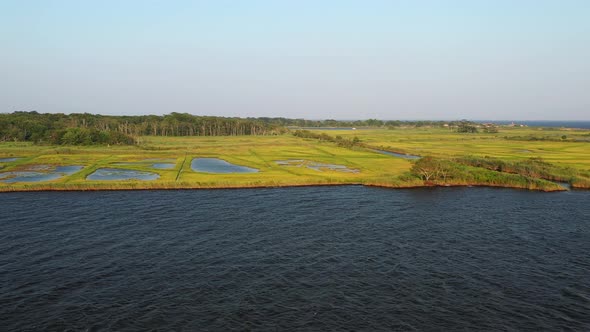 aerial view of the marsh area at East Islip Marina & Park crane shot ...