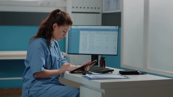 Medical Assistant Working with Computer and Digital Tablet, Stock Footage