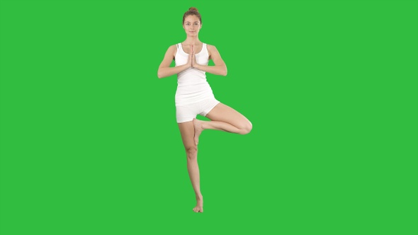 Tree pose standing on one leg, hands in Namaste, prayer, Stock Footage