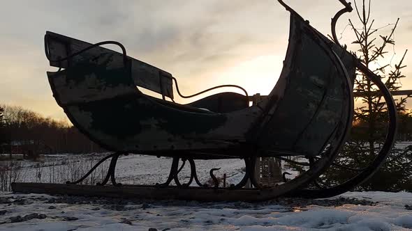 Christmas theme with christmas three and old santa claus sled at sunset ...