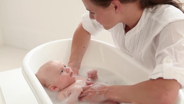 Mother bathing her baby, Stock Footage | VideoHive