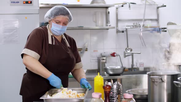 Cooking. Woman Chef, in Protective Gloves and a Mask, Prepares Food in ...