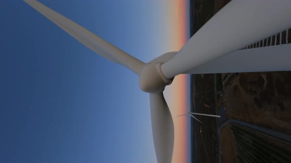 Vertical Dynamic Fpv Shot of White Operative Wind Turbine While ...