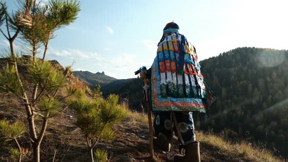 A Forest Wizard in a Traditional Shaman Costume Walks Along a Forest ...