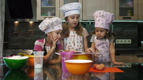Three girls reading a recipe, Stock Footage | VideoHive