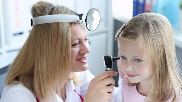 Ent with Frontal Reflector Examining Little Girl Ear Using Otoscope ...
