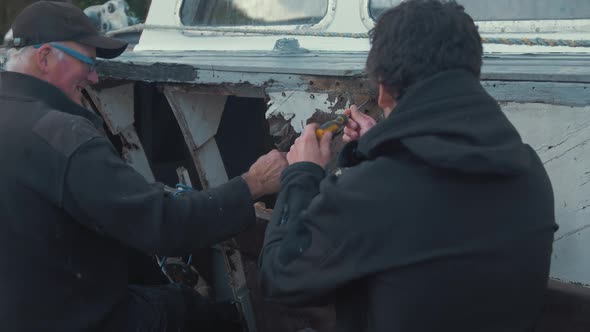Father and son repairing double diagonal planking of Seaplane Tender ...