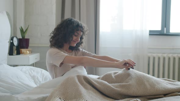 Cheerful Young Lady Waking Up in the Morning Stretching Body and ...