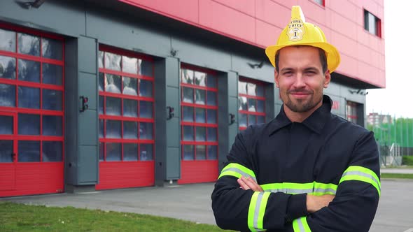 A Young Firefighter Smiles at the Camera and Folds His Hands Across His ...
