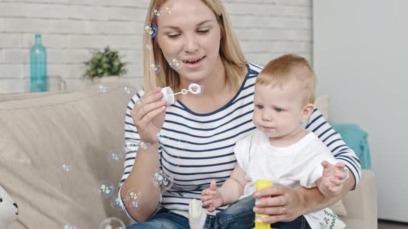 Mother Blowing Bubbles for Baby, Stock Footage | VideoHive