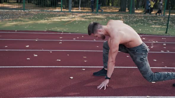Shirtless athlete starts running on the stadium., Stock Footage | VideoHive