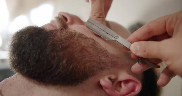 Professional Barber Shaves Customer Beard with Straight Razor, Stock ...
