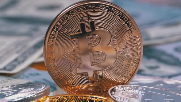 Bronze Bitcoin Coin, BTC and Bills of Dollars Are Rotating, Stock Footage