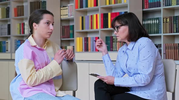 Psychologist High School Behavior Counseling Teenage Student in Library ...