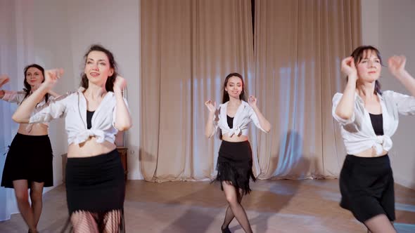 Four Girls in Black Skirts and White Shirts are Dancing Indoors, Stock ...