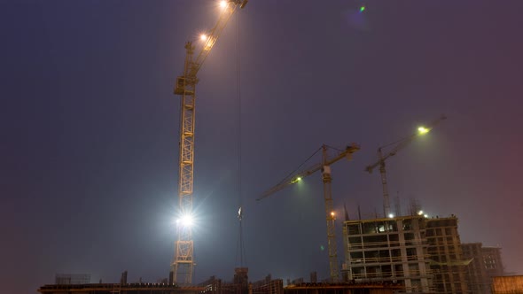 Construction site with crane night time lapse. Building of skyscrapers ...
